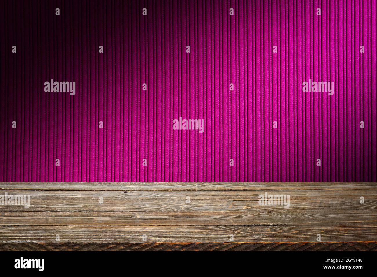 The background is blank wooden boards and a textured striped wall with ...