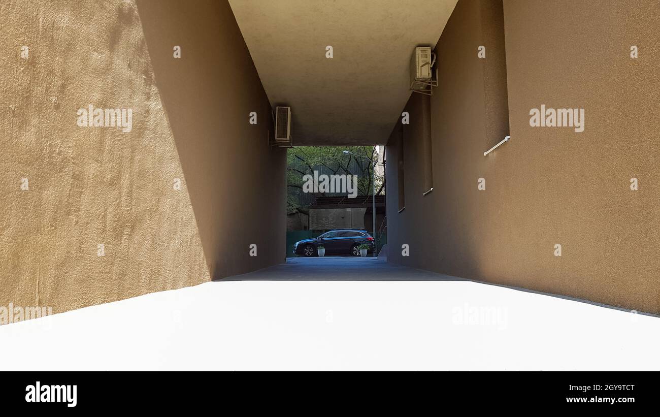 Entrance between two houses in a residential courtyard, the street of ...