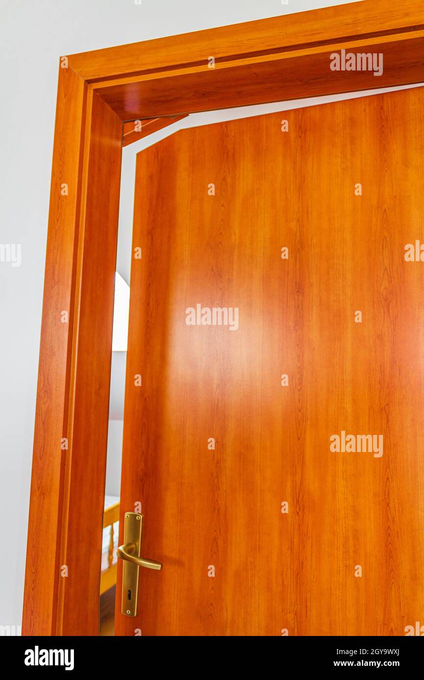 Open wooden door small slit to a white bedroom Stock Photo - Alamy