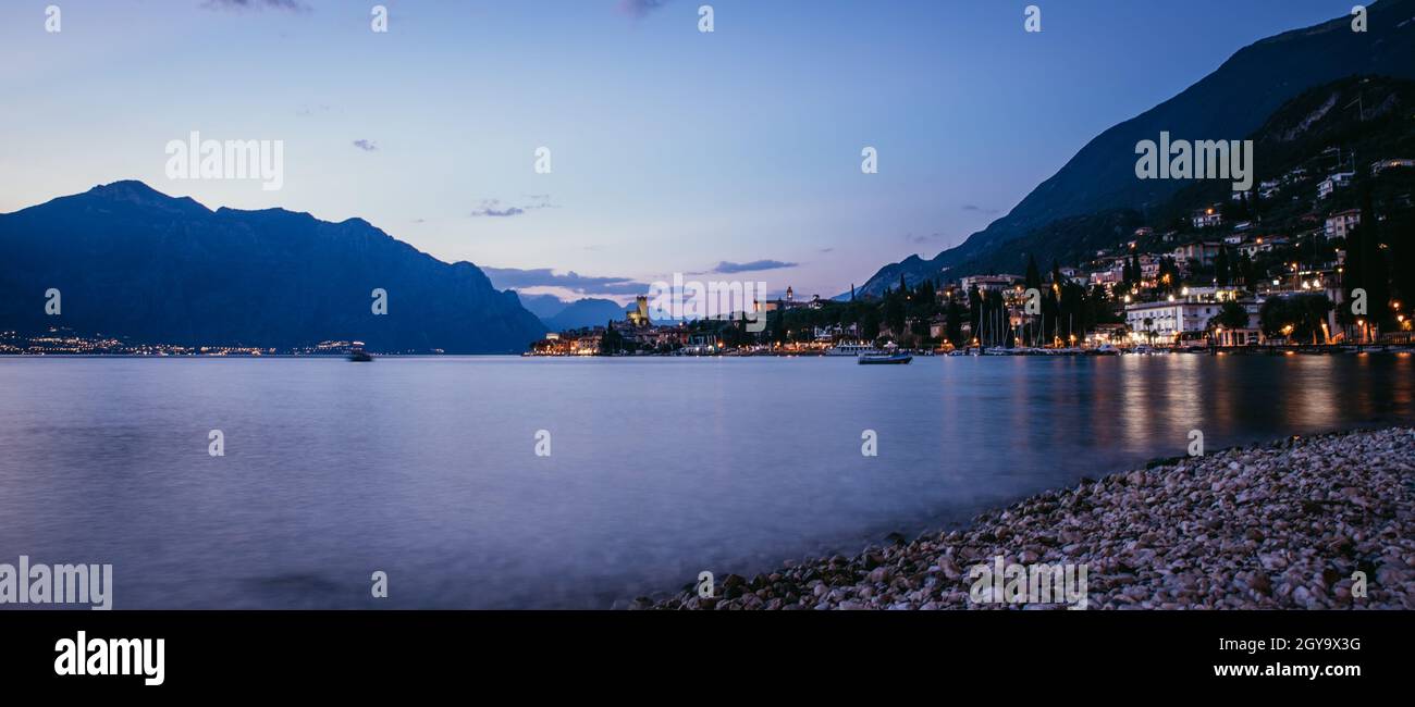 Beautiful evening scenery on the beach with cute little village, lago ...