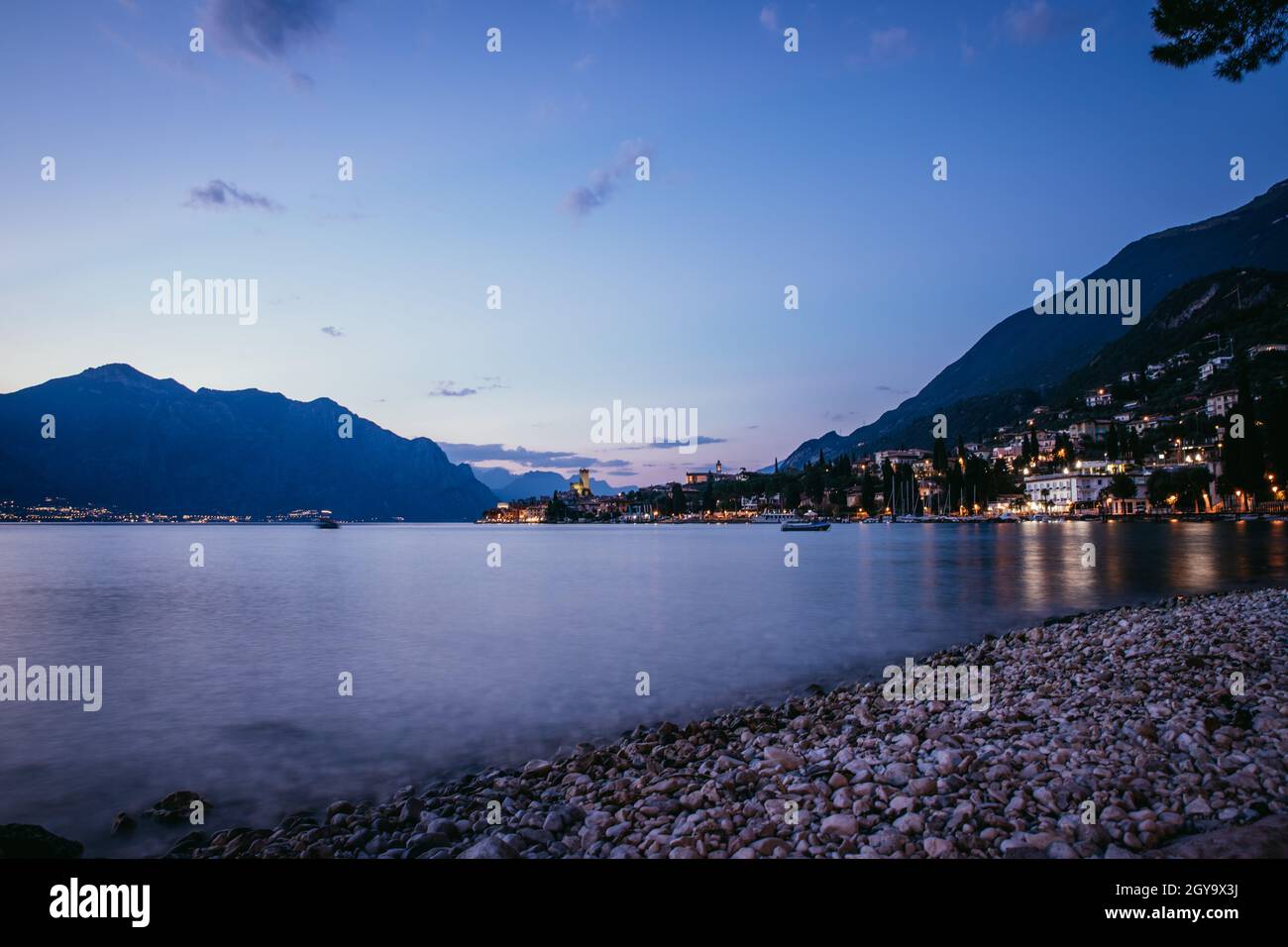 Beautiful evening scenery on the beach with cute little village, lago ...