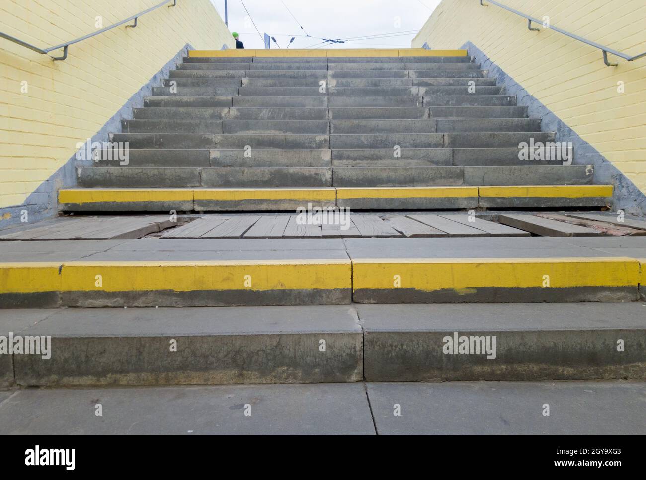 Empty yellow underground pedestrian crossing. Tunnel and daylight at ...