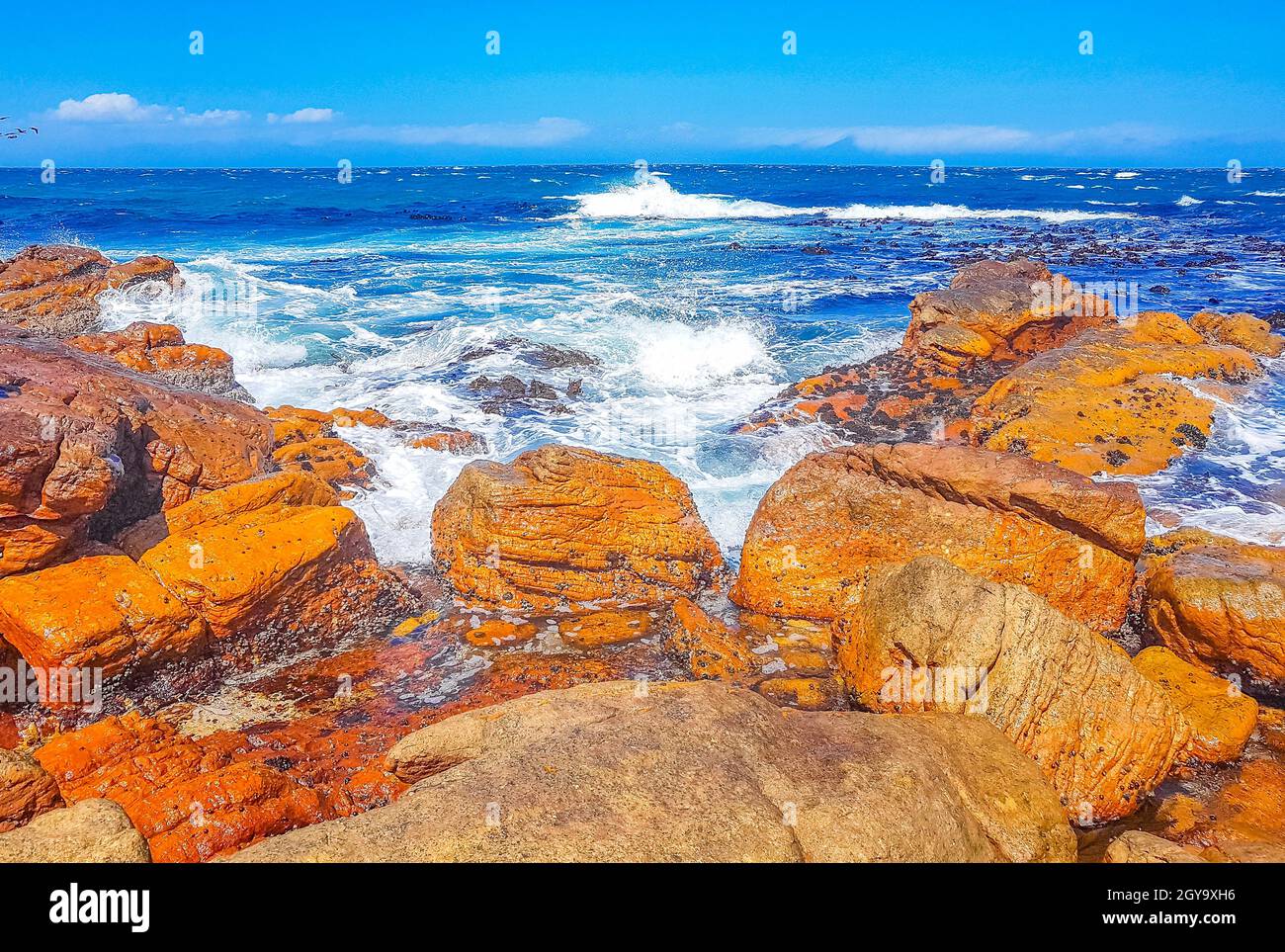 False Bay rough coast landscape with boulders waves and mountains with ...