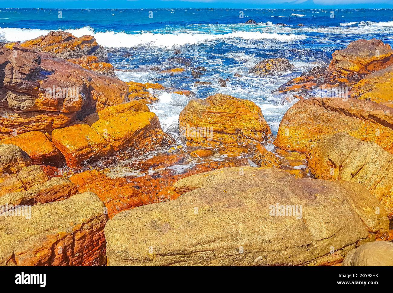 False Bay rough coast landscape with boulders waves and mountains with ...
