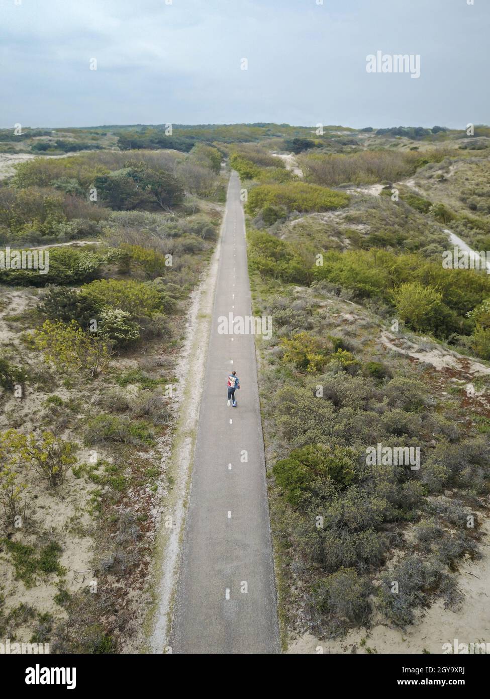 Aerial view, a man by himself on a skateboard in countryside Stock ...