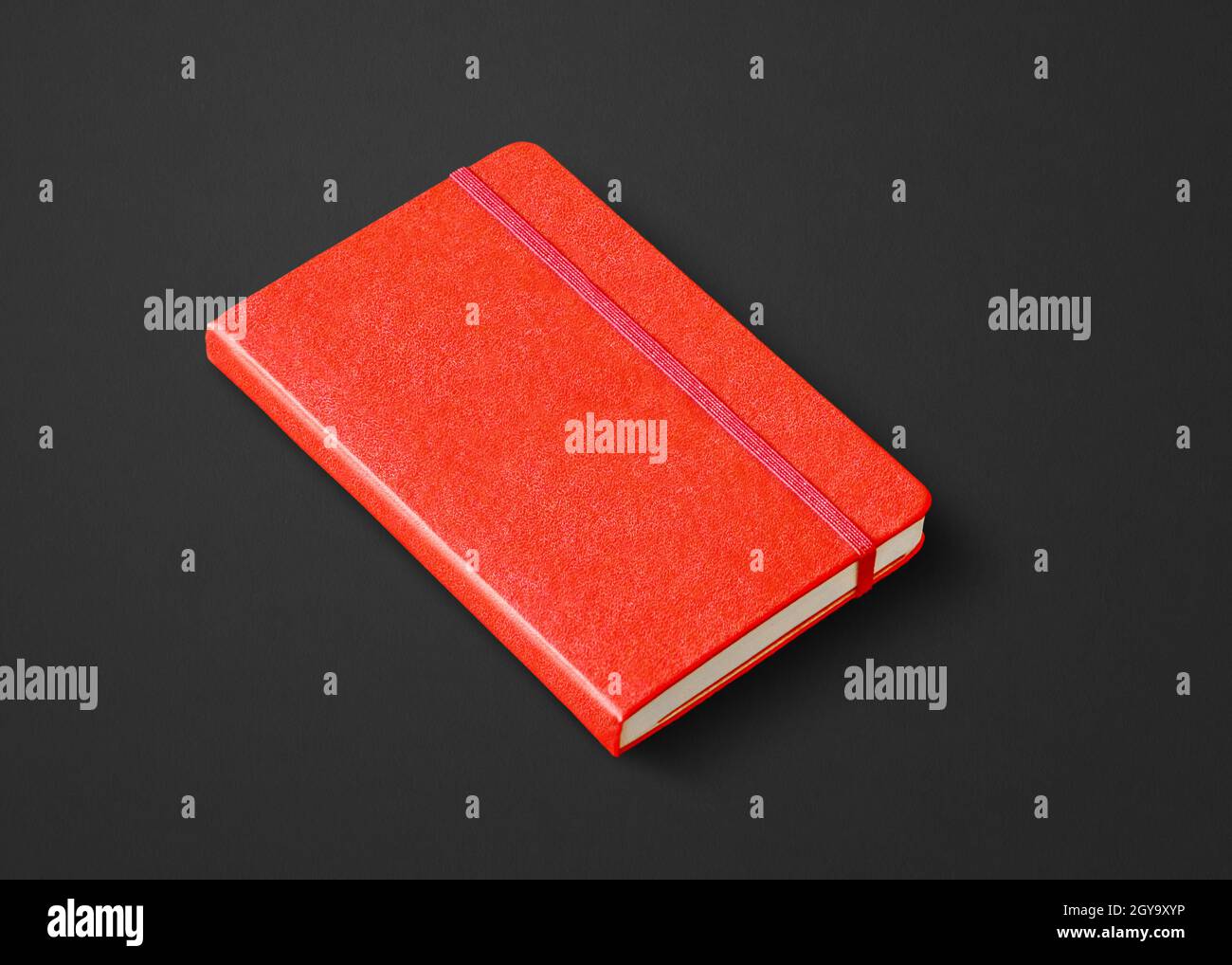 Red closed notebook mockup isolated on black Stock Photo - Alamy