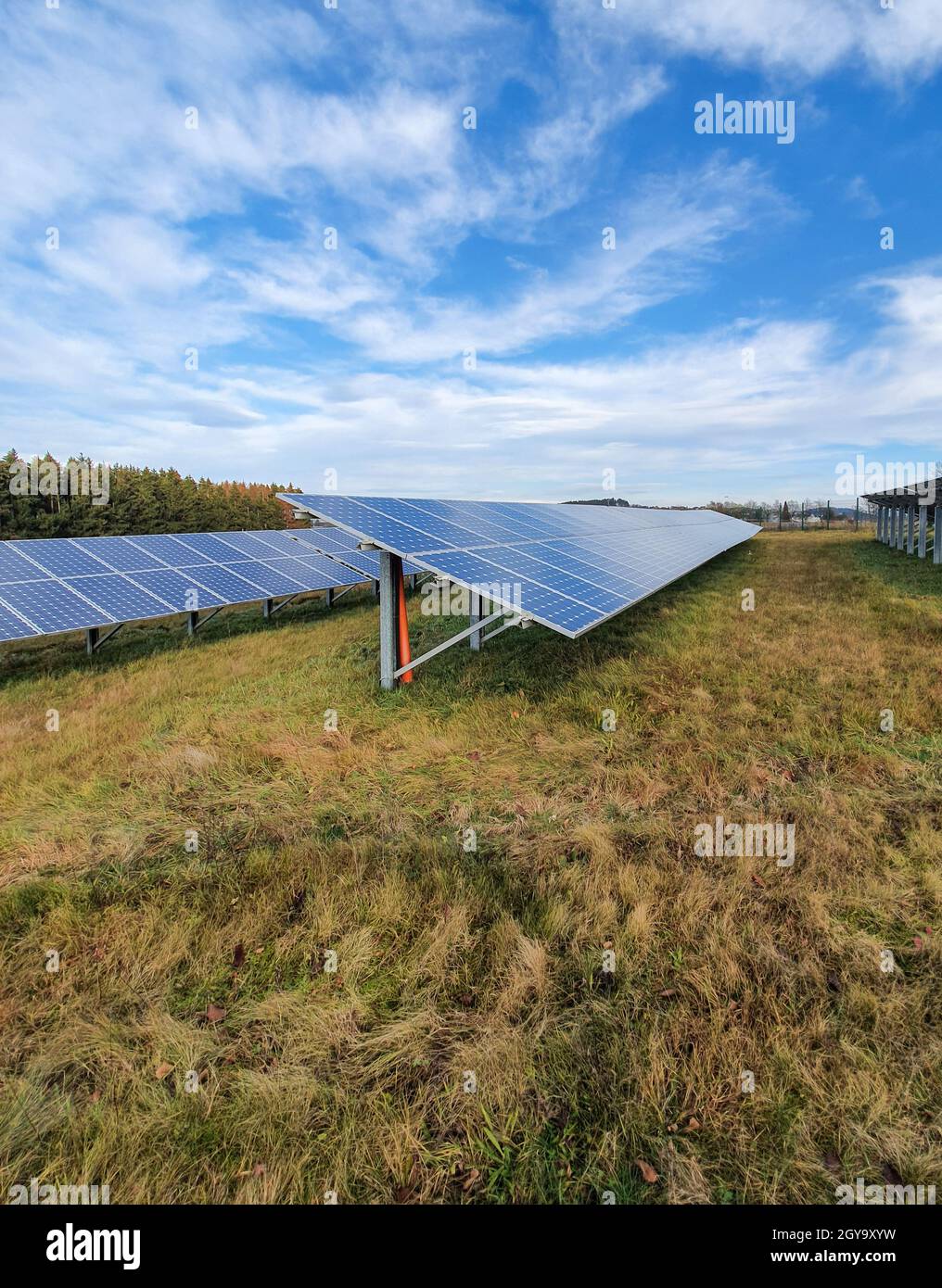 Solar cells on a meadow with blue sky with clouds. Solar panels ...