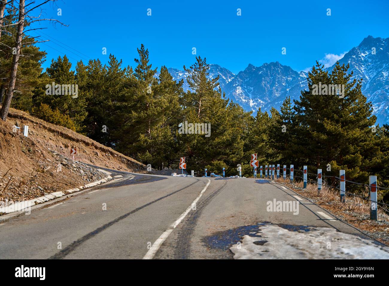 Dangerous winding road among the mountains. Mountain streamer in early ...