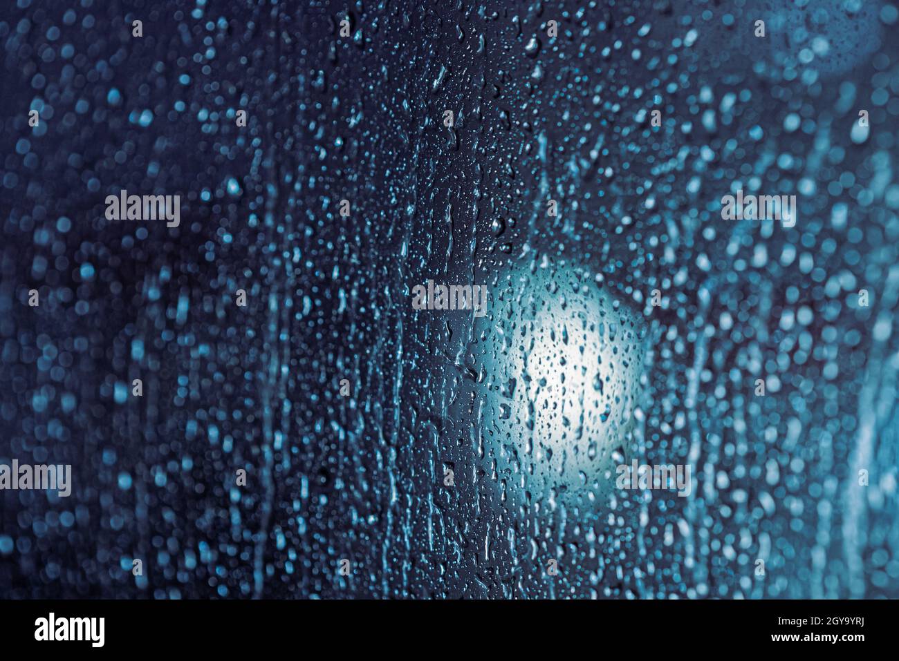 Close up of rain drops on the window in rainy night, cool lights Stock ...