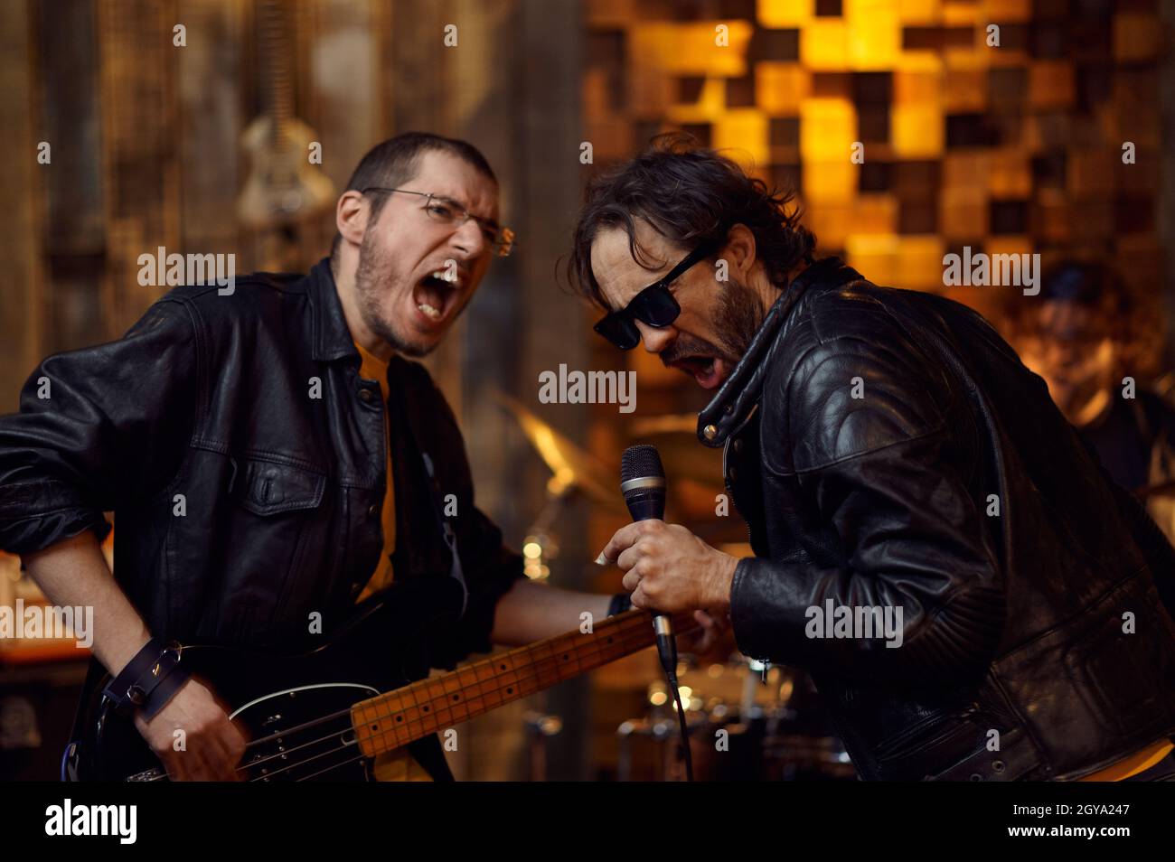 Two artists at microphone, song performing on stage in bar. Rock band ...