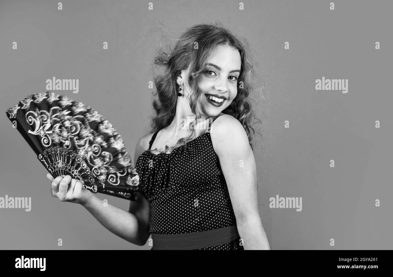 Climate control. Summer heat. Fresh air. Kid girl fanning herself with ...