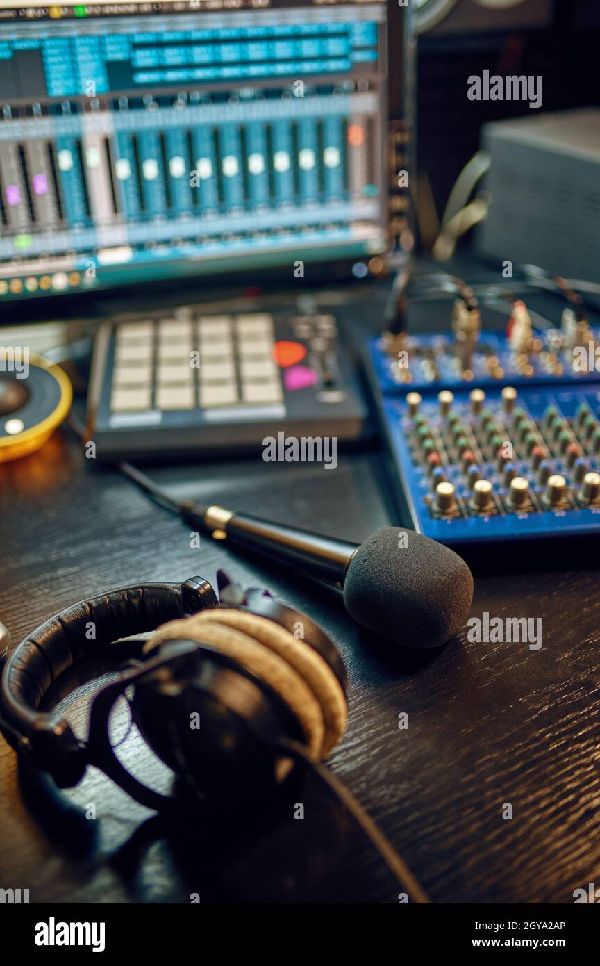 Headphones on the table, recording studio interior on background ...