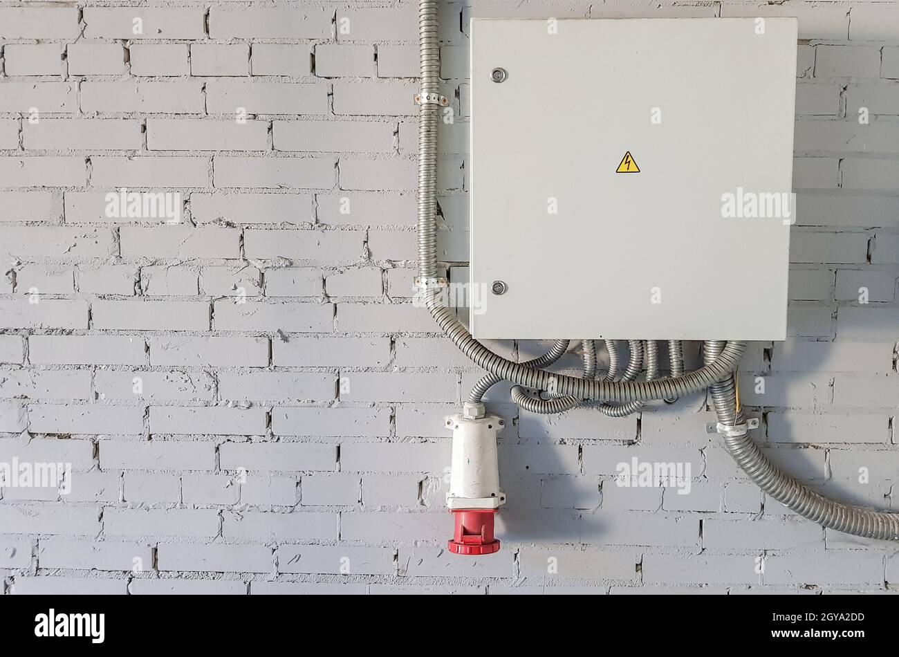 Gray wall mounted power supply, electrical panel, danger sign. Control ...