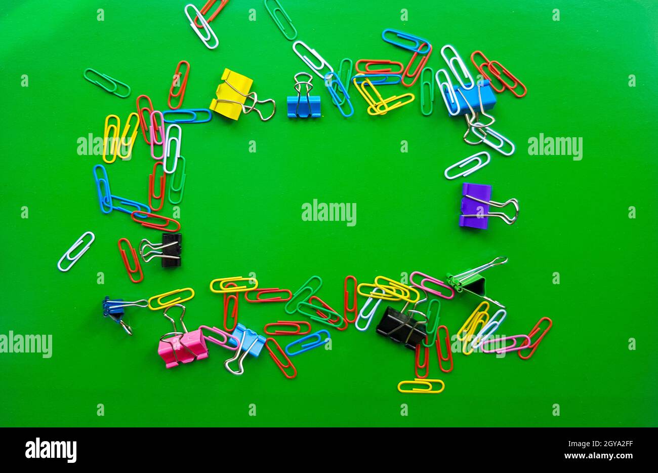 pile of paper clips isolated on green background, documents, office ...