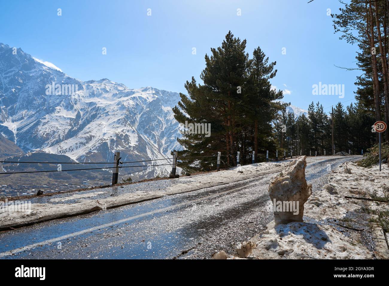 Dangerous winding road among the mountains. Mountain streamer in early ...