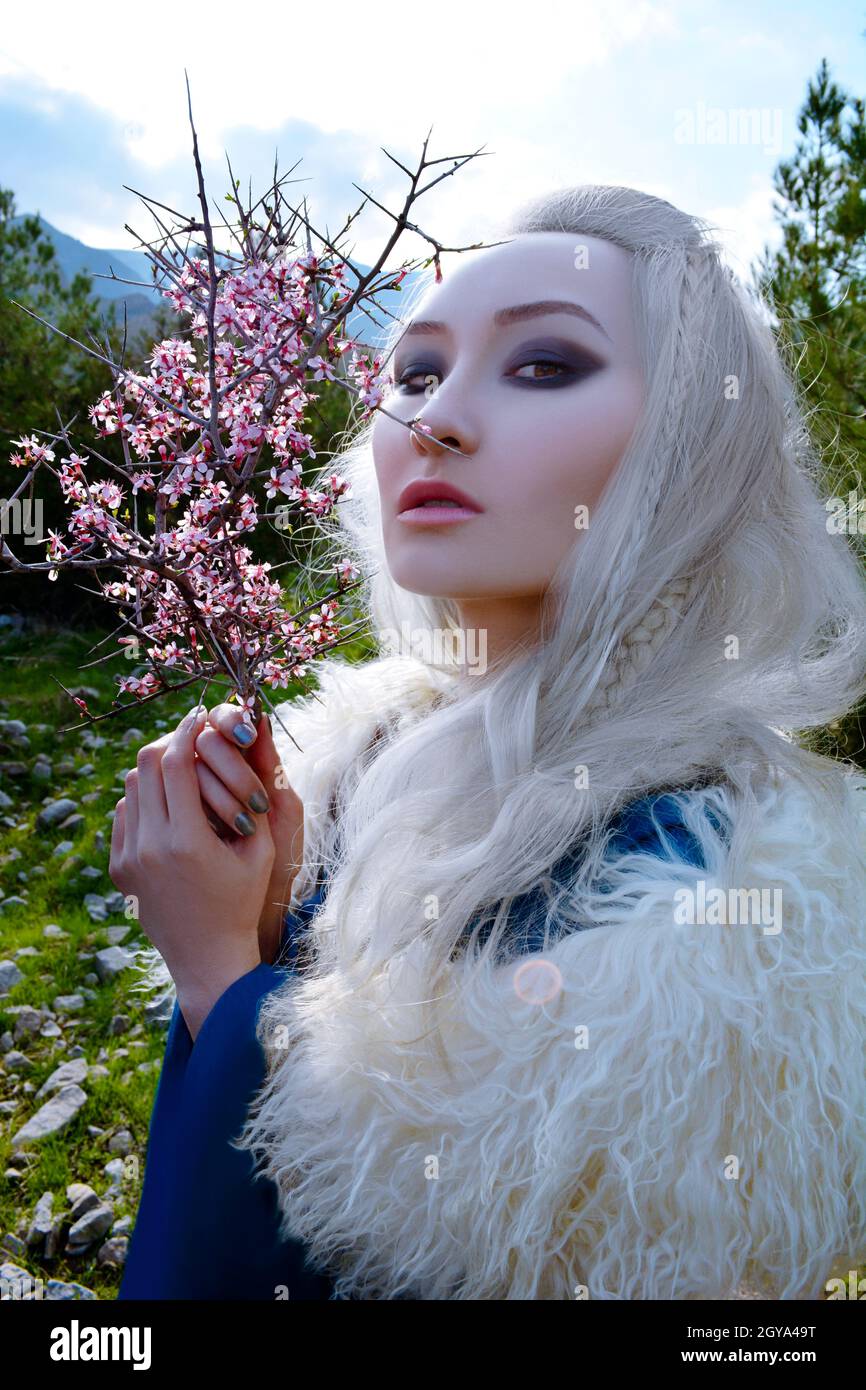 Viking Girl with pink flowers Stock Photo - Alamy