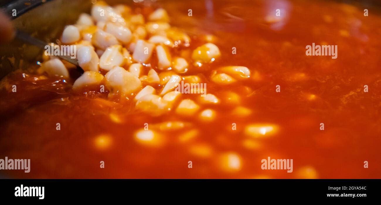 Delicious traditional Mexican pozole with corn kernels in cooking pot ...