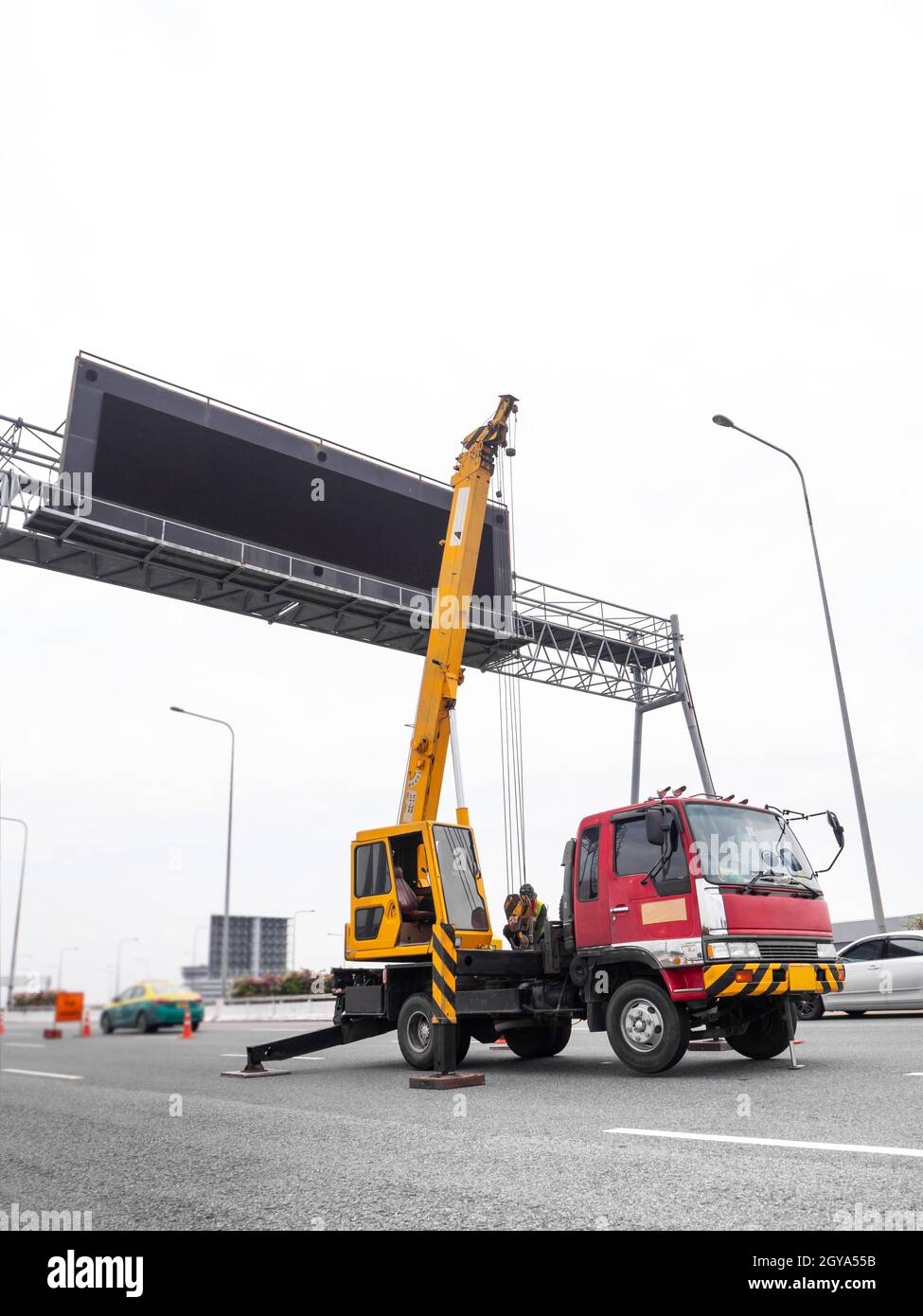 Construction site crane is lifting a led signboard Blank billboard on ...