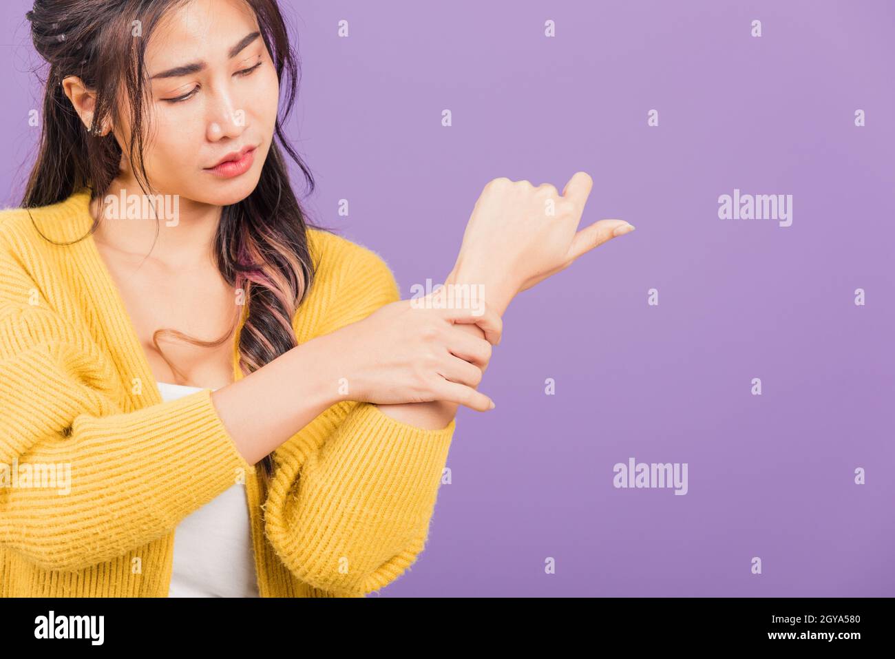 Portrait of Asian beautiful young woman sad with wrist pain from carpal ...
