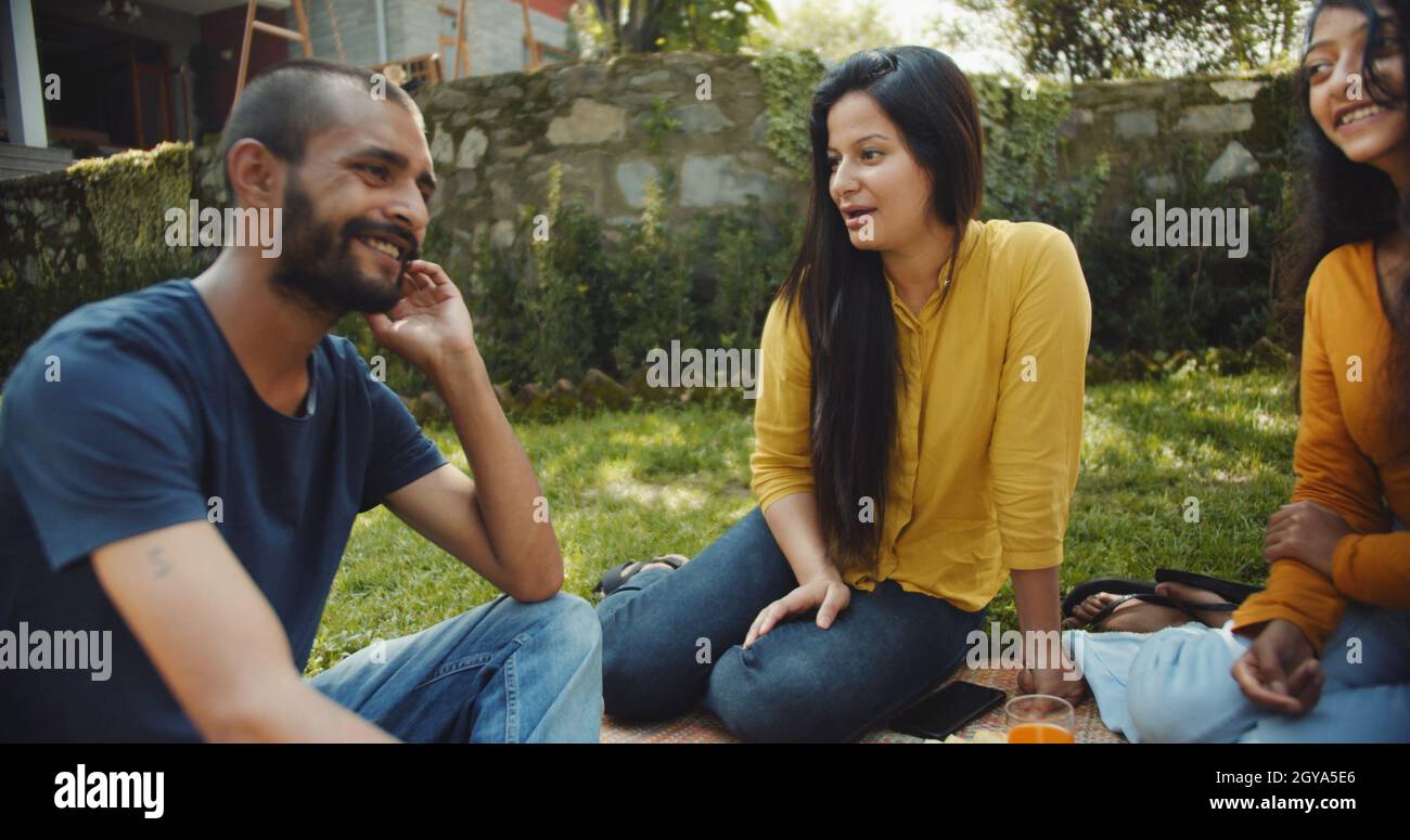 Close up shot of a three South Asian friends happily making a picnic in ...