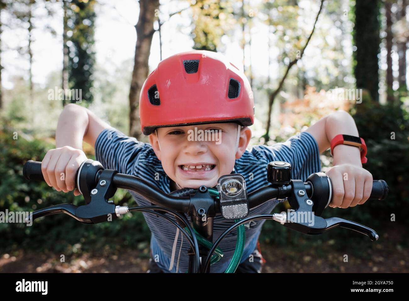portrait of boy leaning on his bike smiling in the forest Stock Photo ...