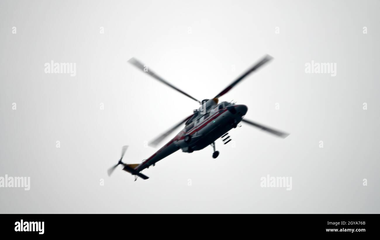 Rescue helicopter with a lowered ramp (safety ladder). Blurred ...