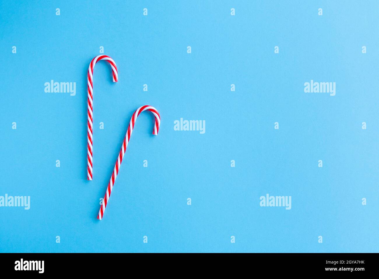 Christmas composition. Christmas two candy canes flat lay, top view on pastel pink background ...
