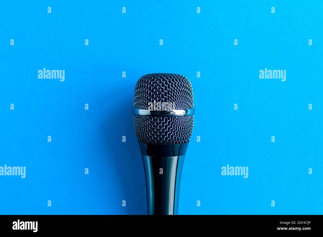 Microphone on a colorful blue background close up. Singing, writing ...