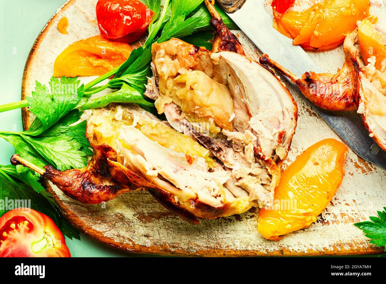 Cut quails roasted in tomato sauce. Fried quails meat on a cutting ...