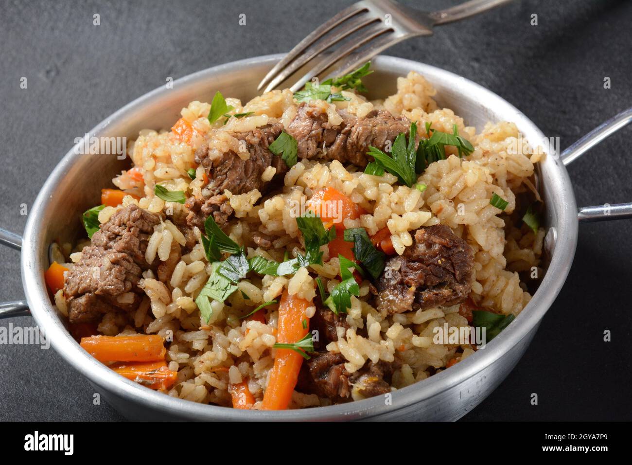 Fried and stewed beef meat with rice. Uzbek cuisine pilaf (plov Stock ...