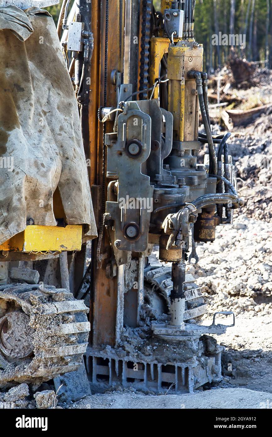 Mini-drilling rig on crawler track on site of sawn forest where large ...