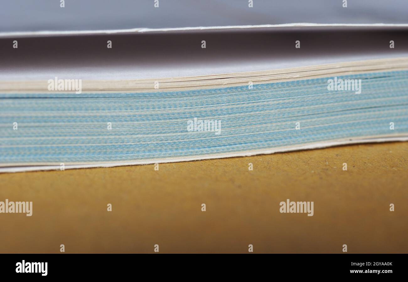 side view of a book on a desk Stock Photo - Alamy