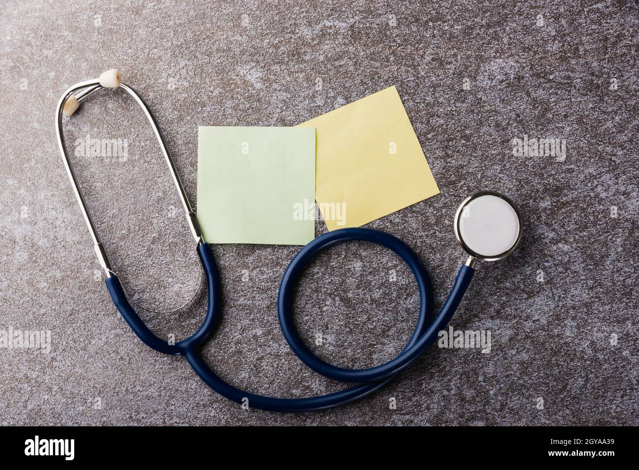 Above the doctor office table desk with blank paper stick note yellow ...
