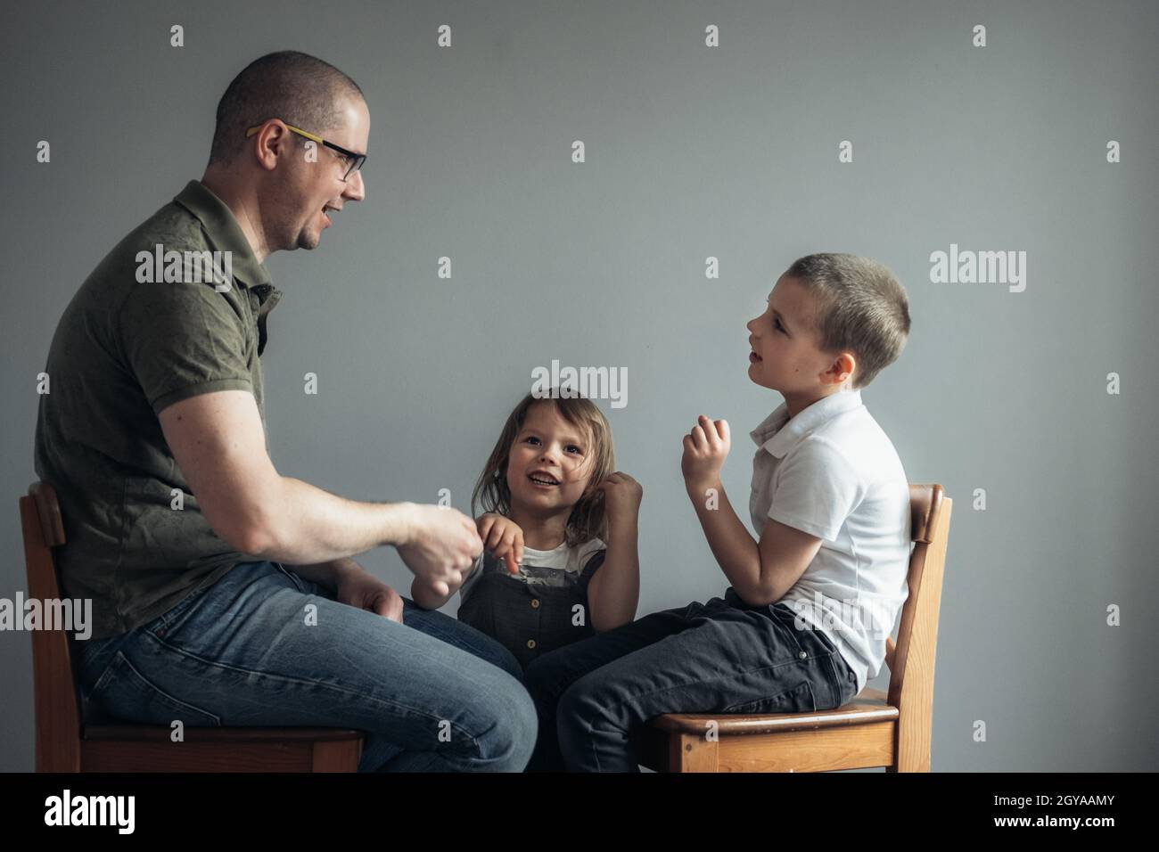 Two children talking to adult hi-res stock photography and images - Alamy