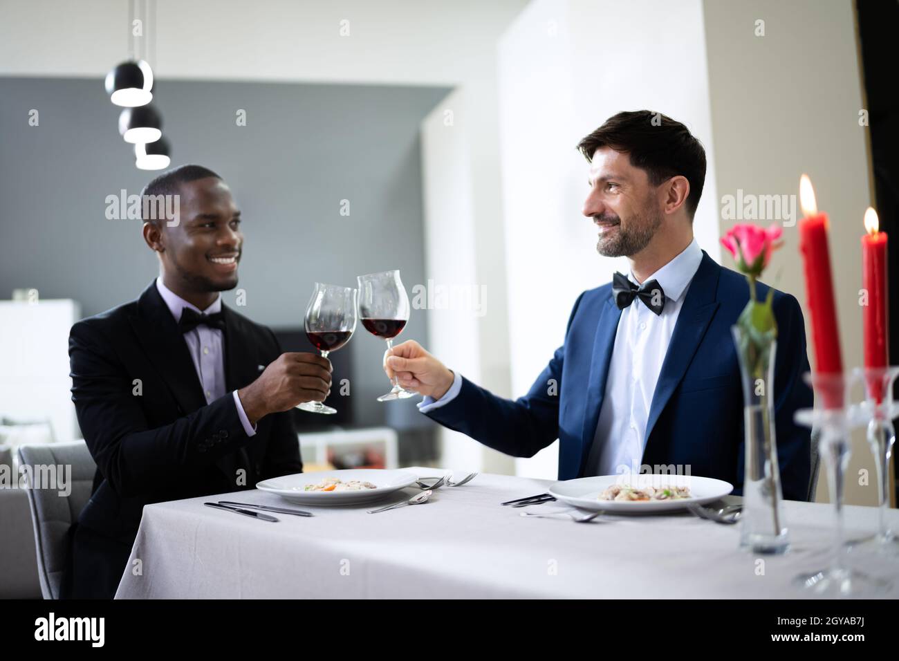 Gay Couple Having Dinner In Restaurant. People In Love Stock Photo - Alamy