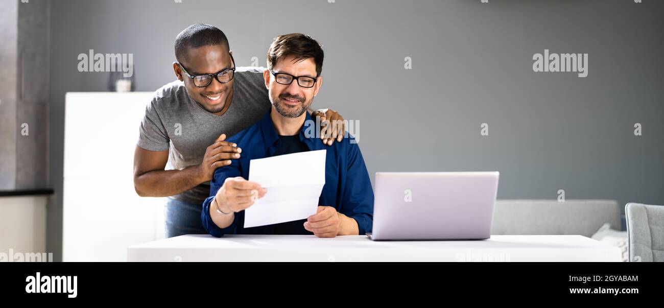 Happy Gay Couple Reading Letter Or Mail Stock Photo - Alamy