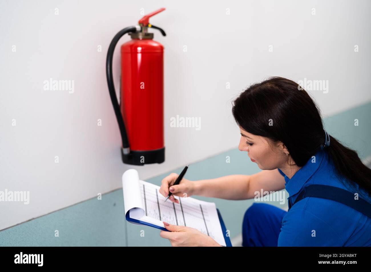Safety Checking Fire Extinguisher. Emergency Prevention System Stock ...