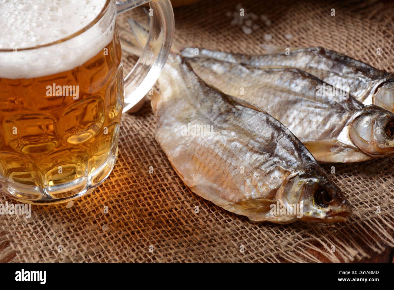 Salty dried fish roach and Beer mug with light foamed beer Stock Photo ...