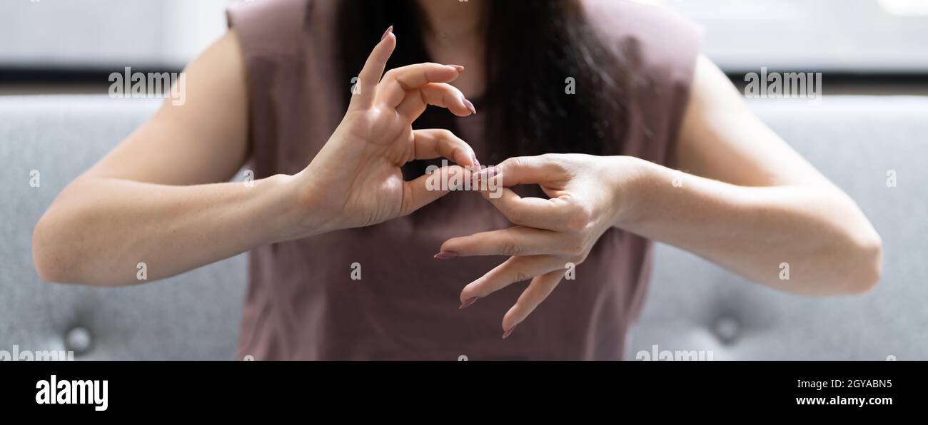 Adult Learning Sign Language For Deaf Disabled Stock Photo - Alamy