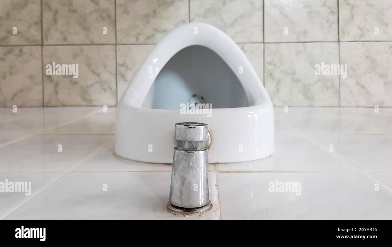 Public toilet with one ceramic urinal. Urinals prepare bowls for men ...