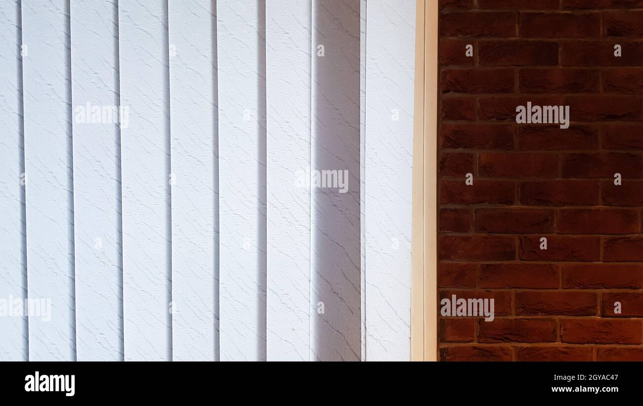 Large window with vertical white or gray blinds, loft, brick wall ...