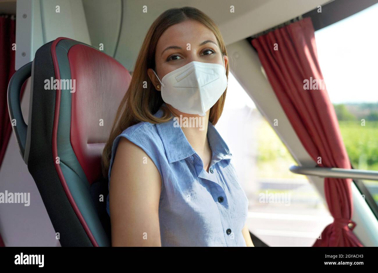 Attractive smiling female passenger on bus looking at camera Stock ...