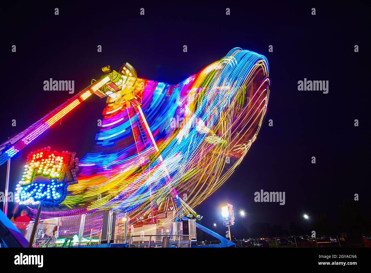 Freak Out fair and carnival ride in a motion of color Stock Photo - Alamy