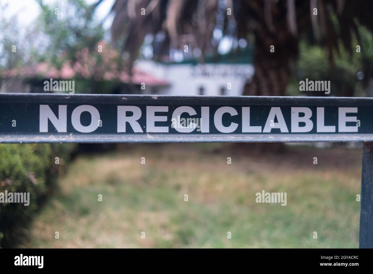 Spanish sign for non-recyclable trash with trees as background Stock ...