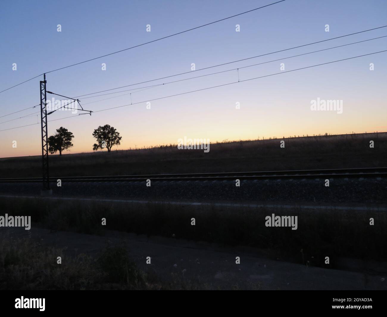 train path sunset electric sky sunset horizon Stock Photo - Alamy
