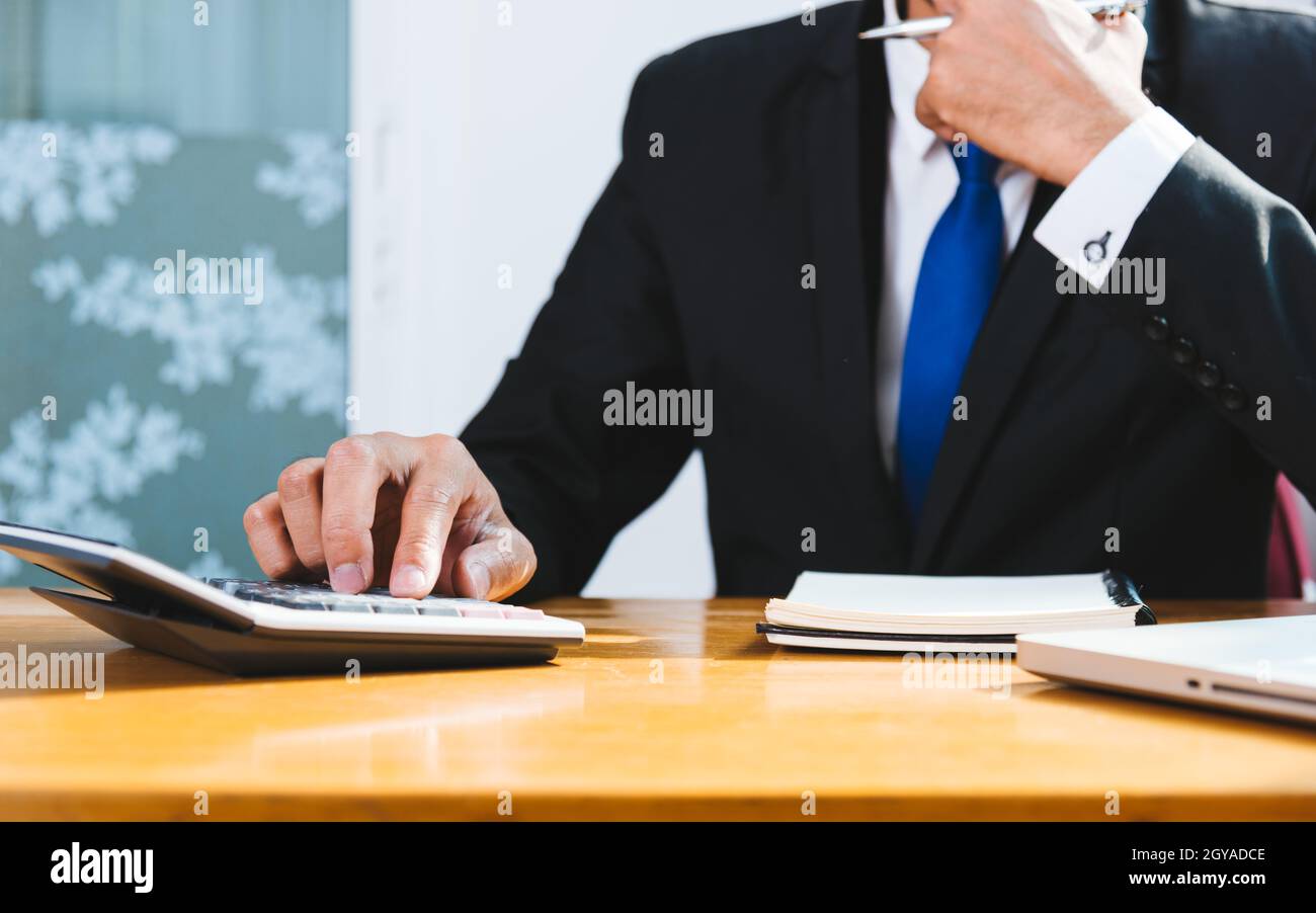 Business man accounting using calculating and work with laptop computer ...