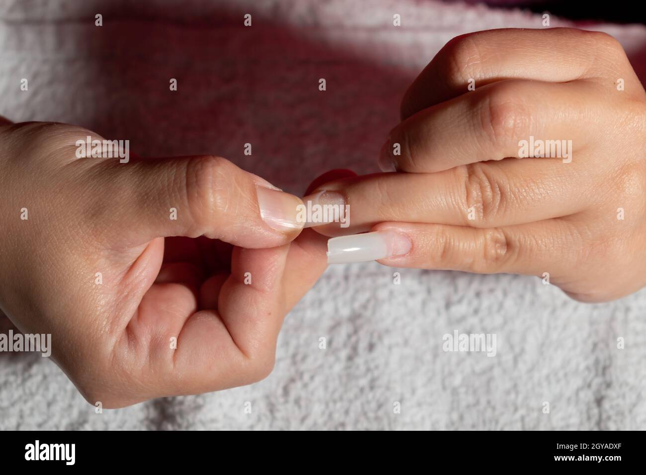 Process of nail extension with gluing artificial nails in the nail ...