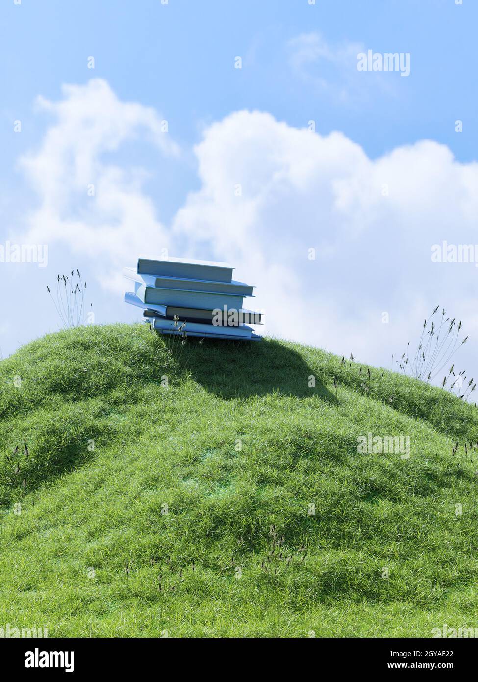 Pile of books on a small grassy hill. Education or study concept ...