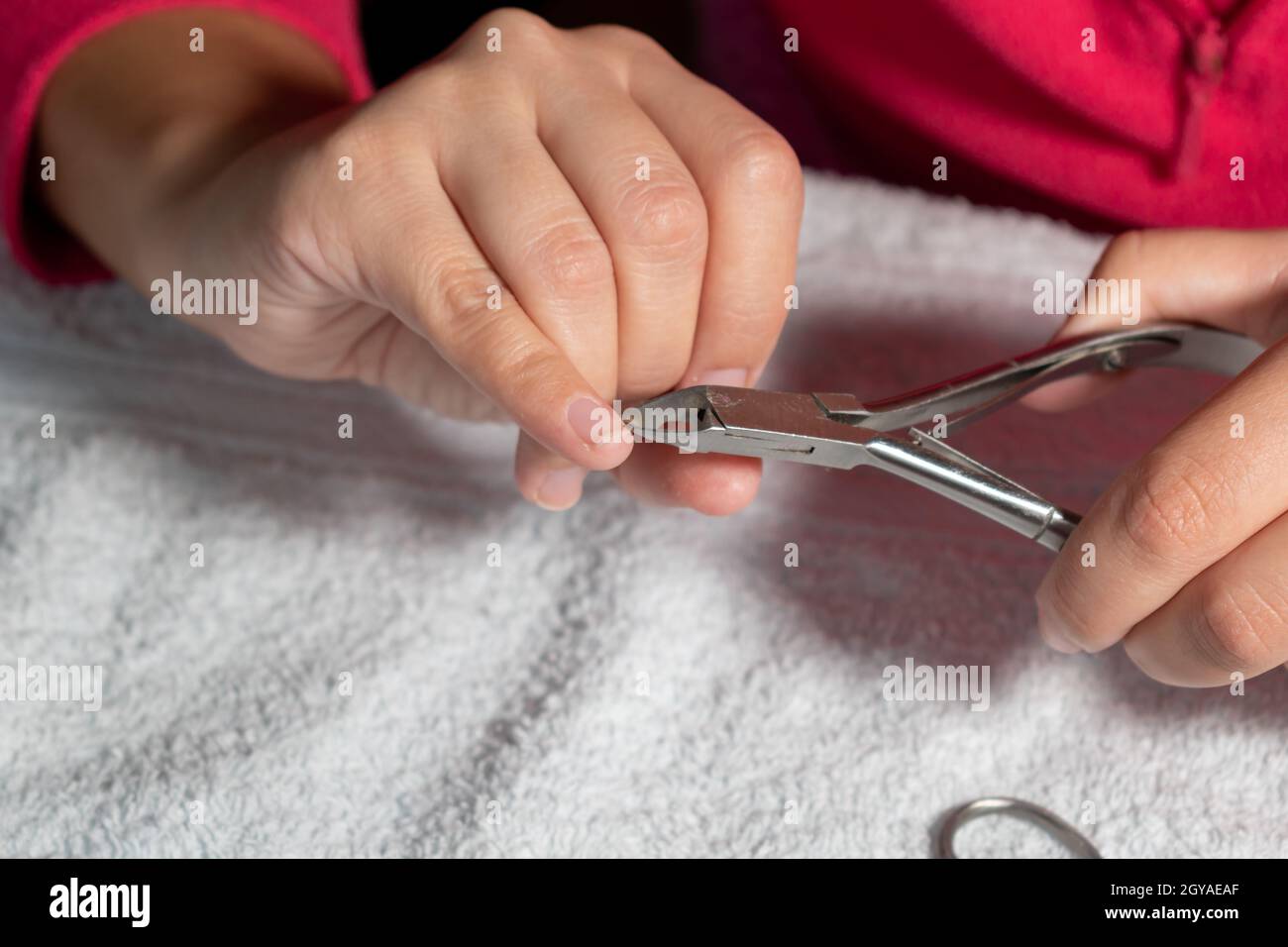 Process of cutting fingernails on the white terry cloth in the nail ...