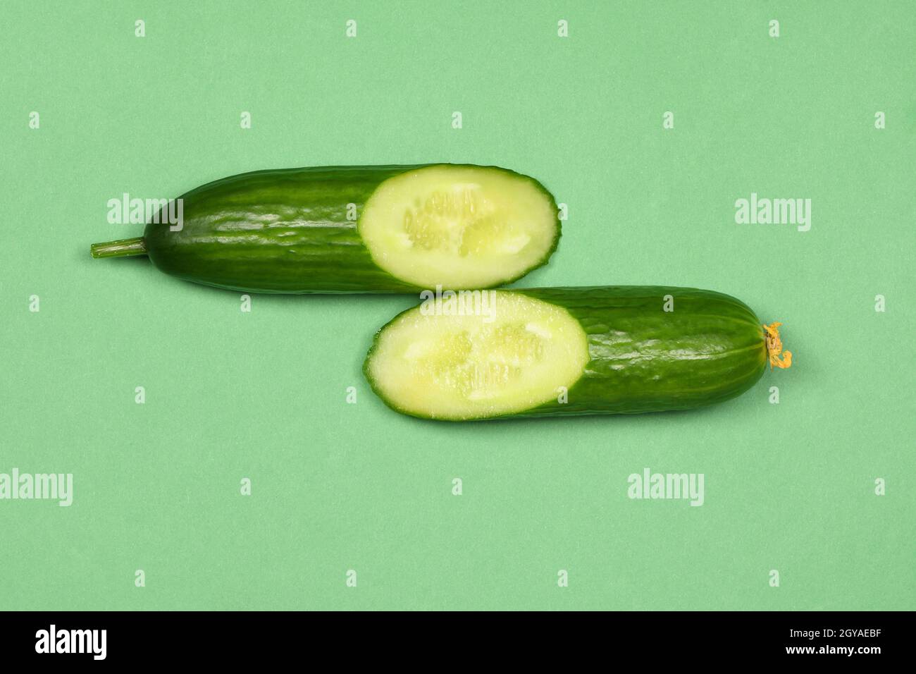 Fresh long cucumber over a green background. High resolution photo ...